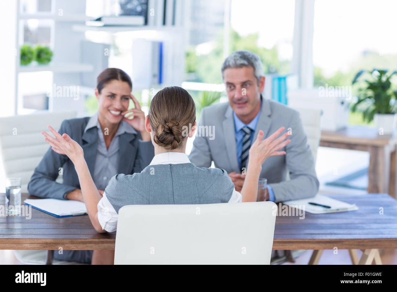 Business people interviewing young businesswoman Stock Photo - Alamy