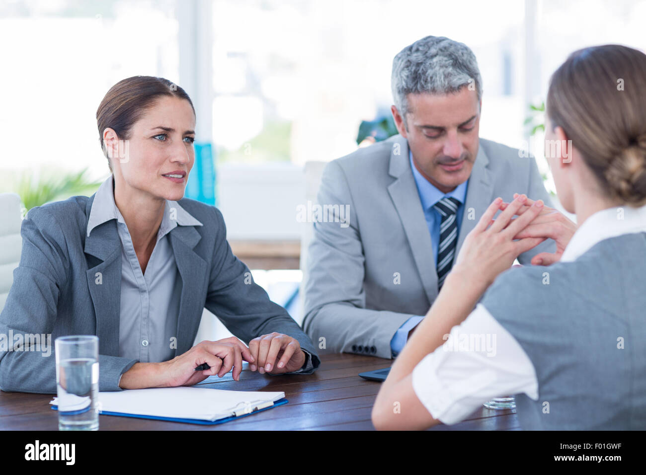Business people interviewing young businesswoman Stock Photo - Alamy