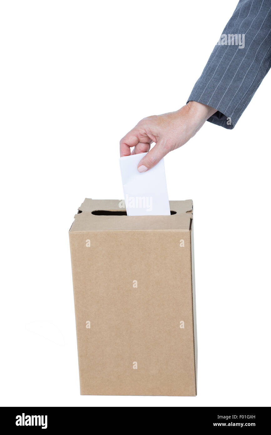Businessman putting ballot in vote box Stock Photo - Alamy