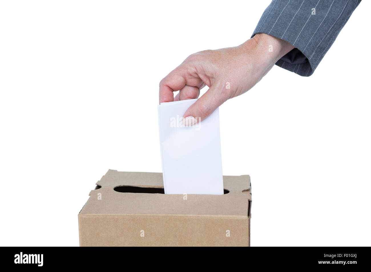 Businessman putting ballot in vote box Stock Photo - Alamy