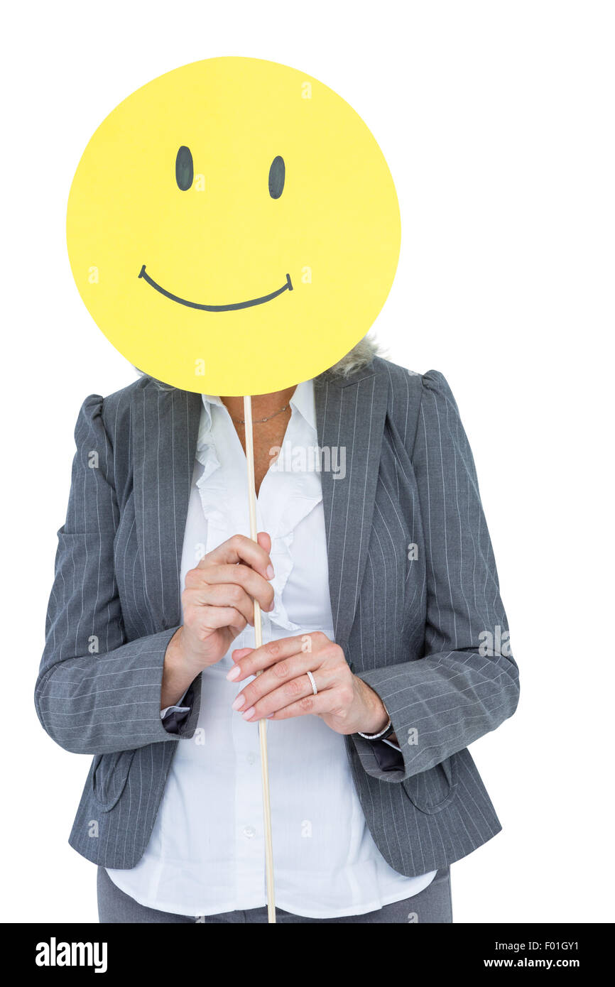 Businesswoman holding happy smiley face Stock Photo - Alamy