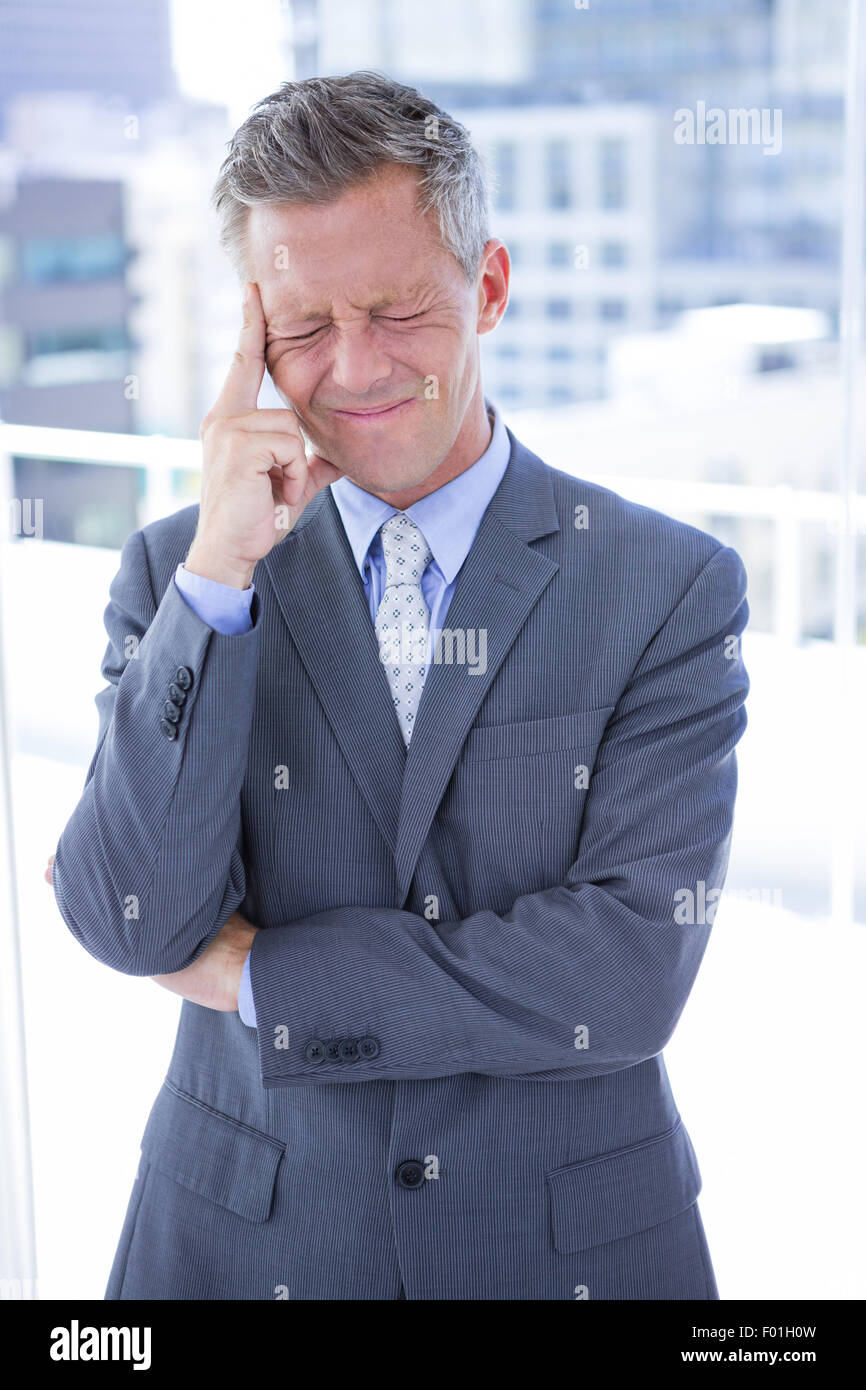 Businessman having a headache Stock Photo - Alamy