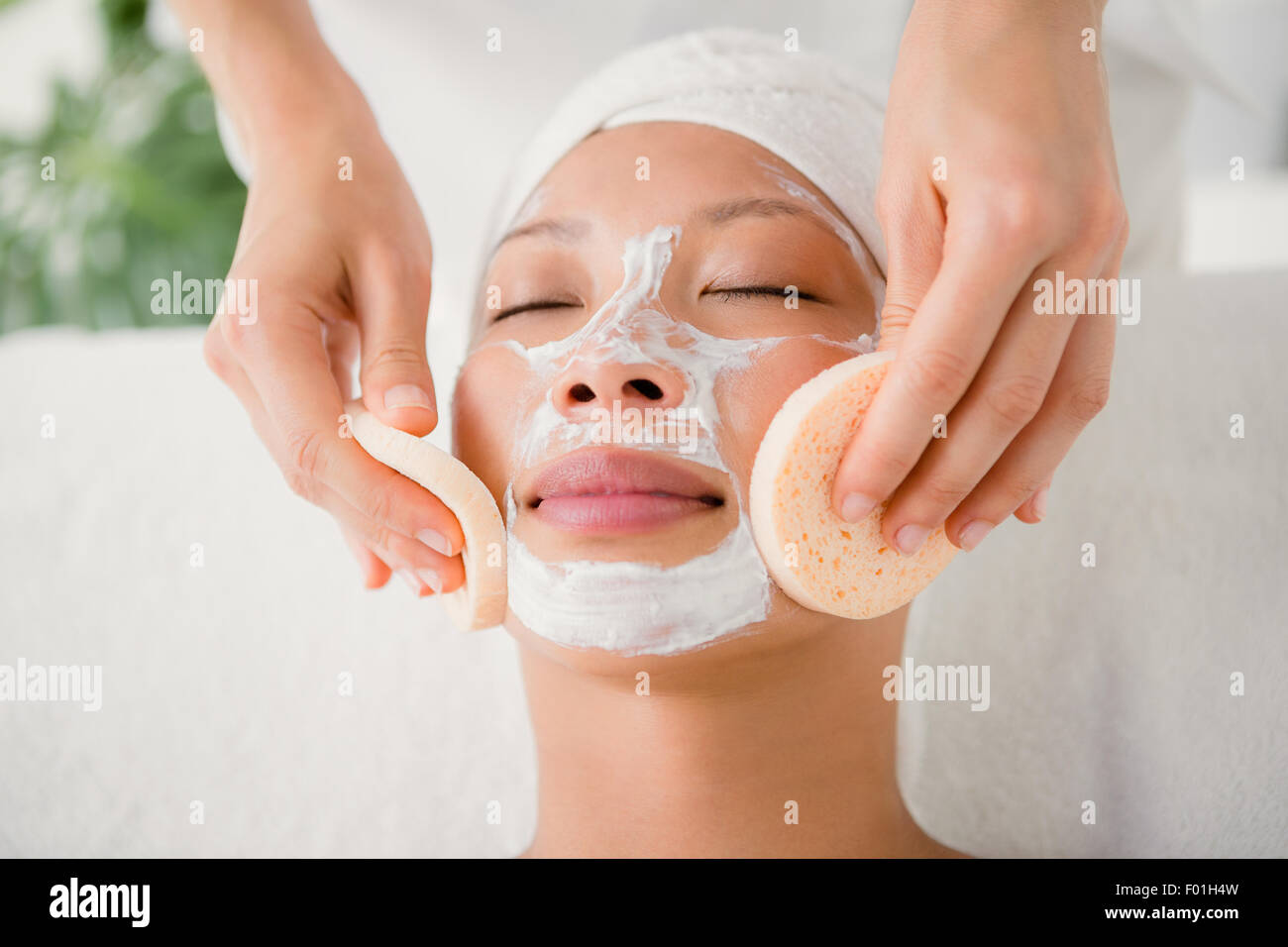Hand cleaning womans face with cotton swabs Stock Photo - Alamy