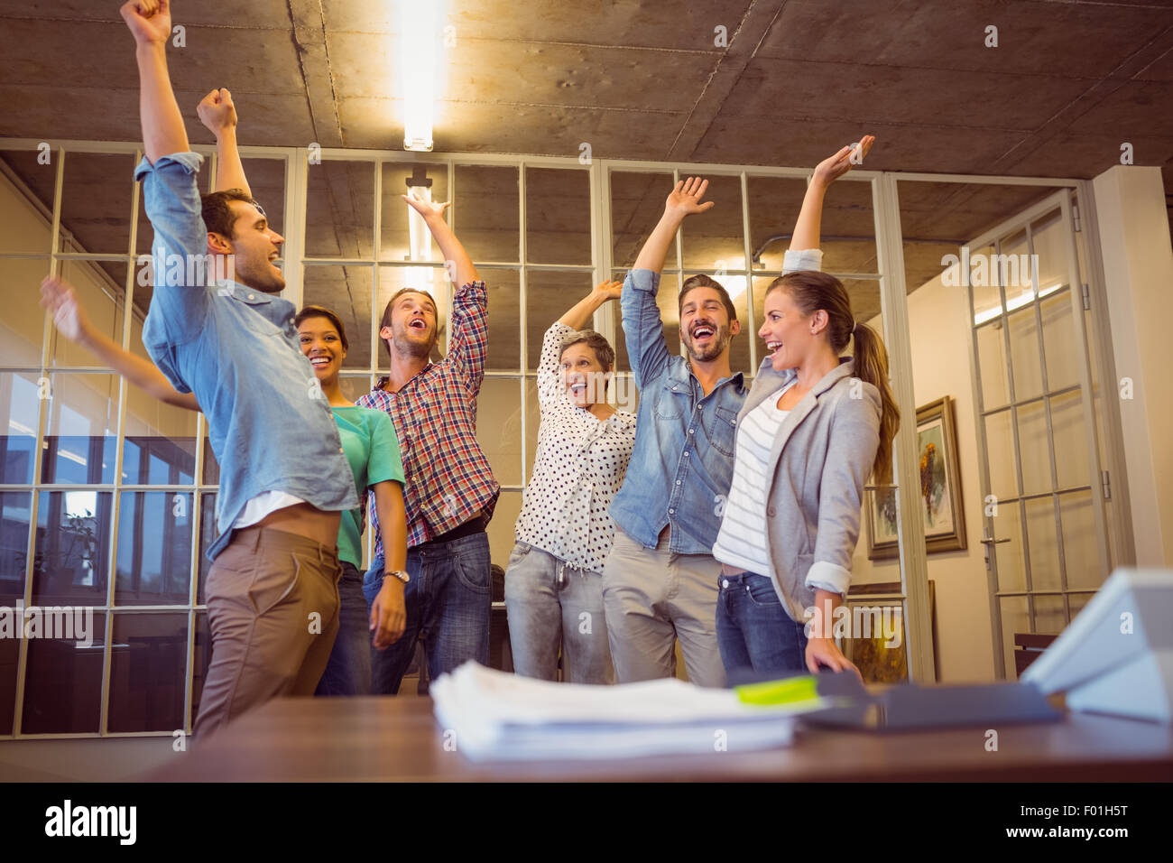 Creative business team waving their hands Stock Photo - Alamy