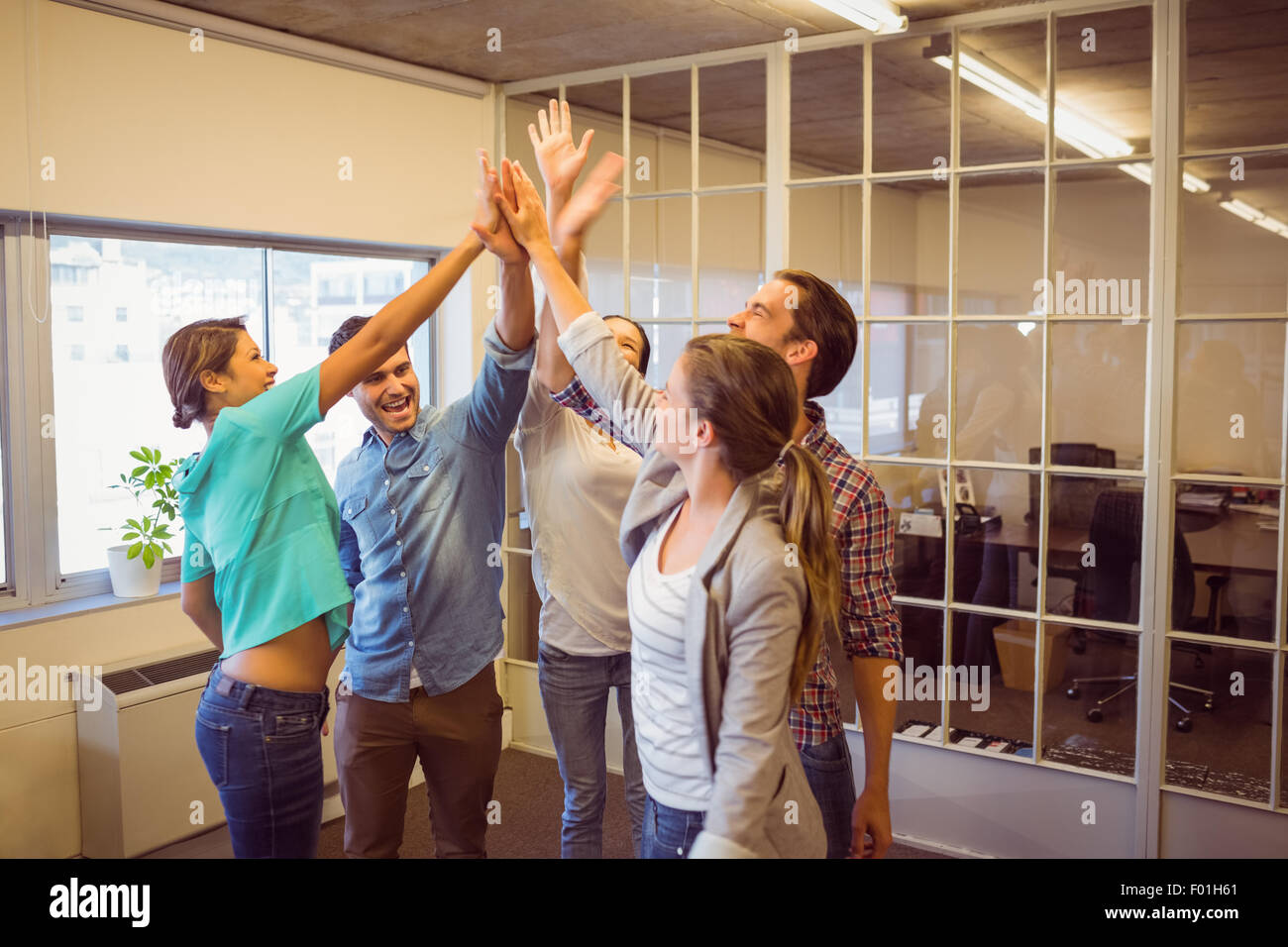 Creative business team raising their hands Stock Photo - Alamy
