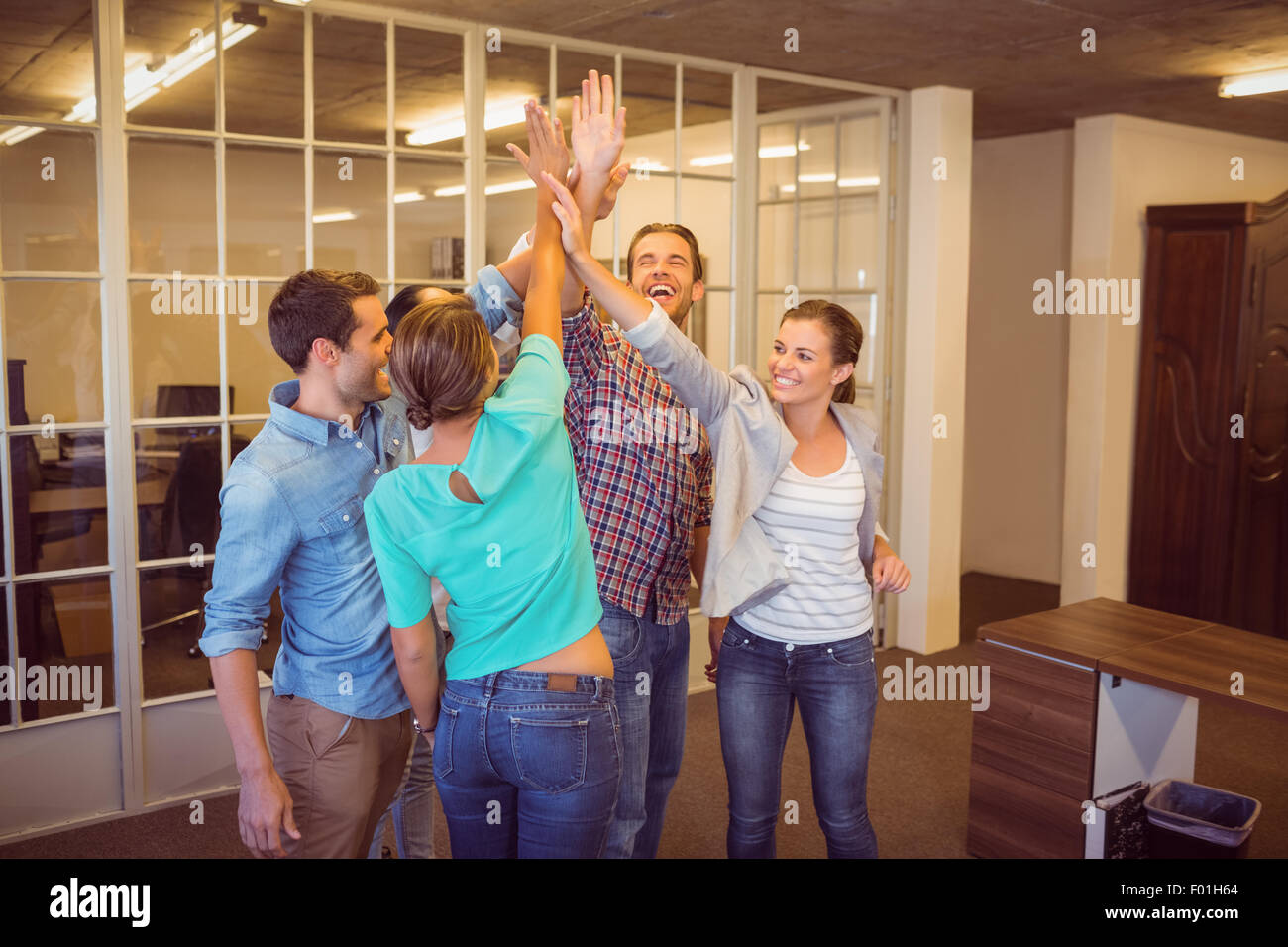 Creative business team raising their hands Stock Photo - Alamy