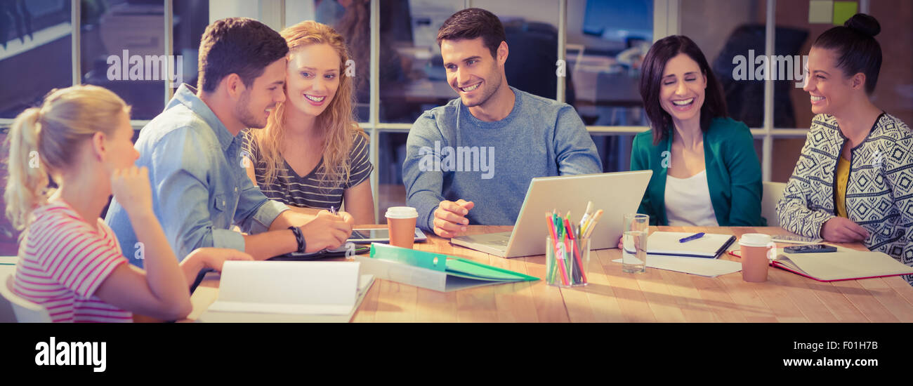 Group of young colleagues using laptop Stock Photo - Alamy