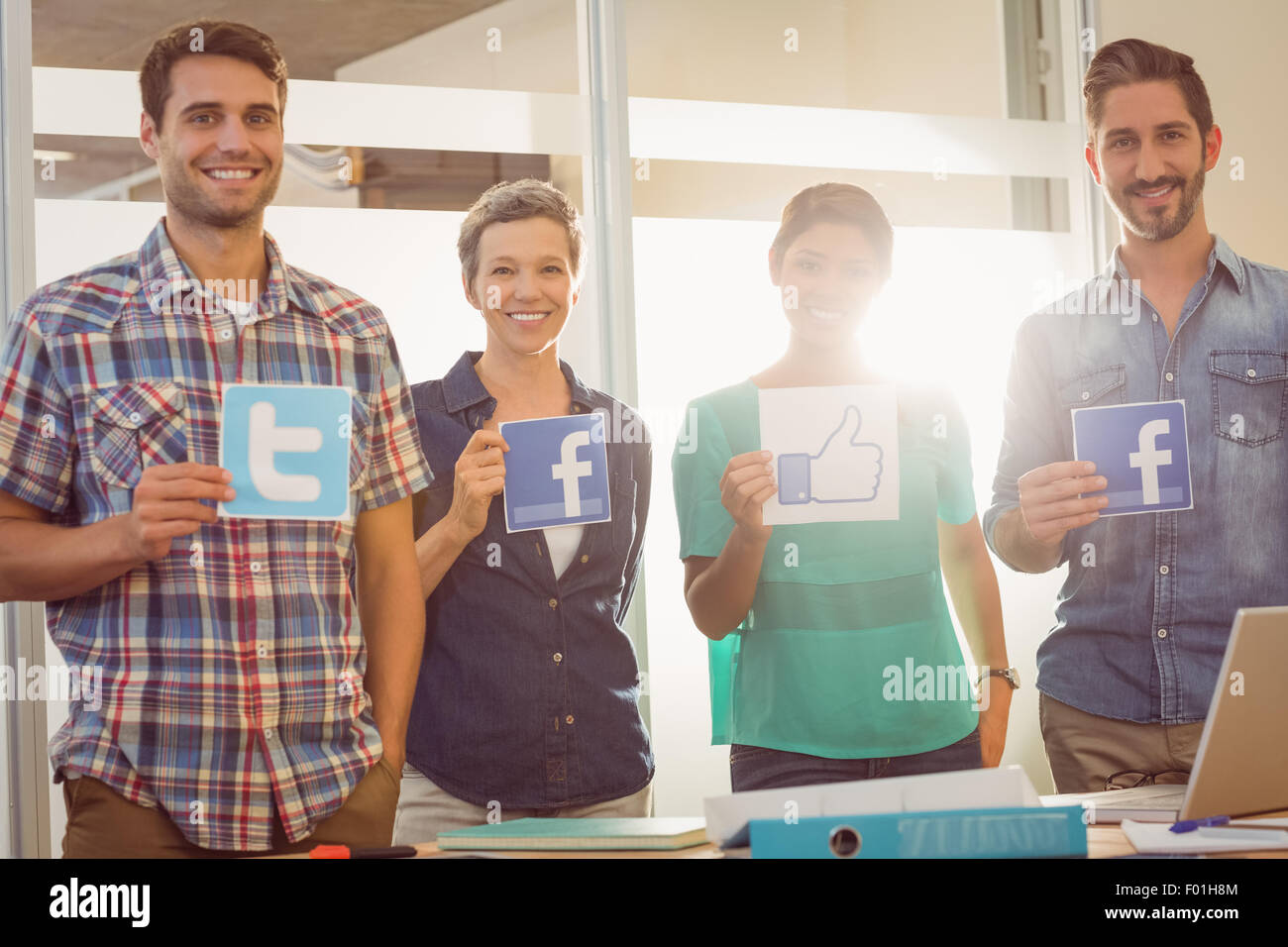 Colleagues holding sign from famous social networks Stock Photo - Alamy