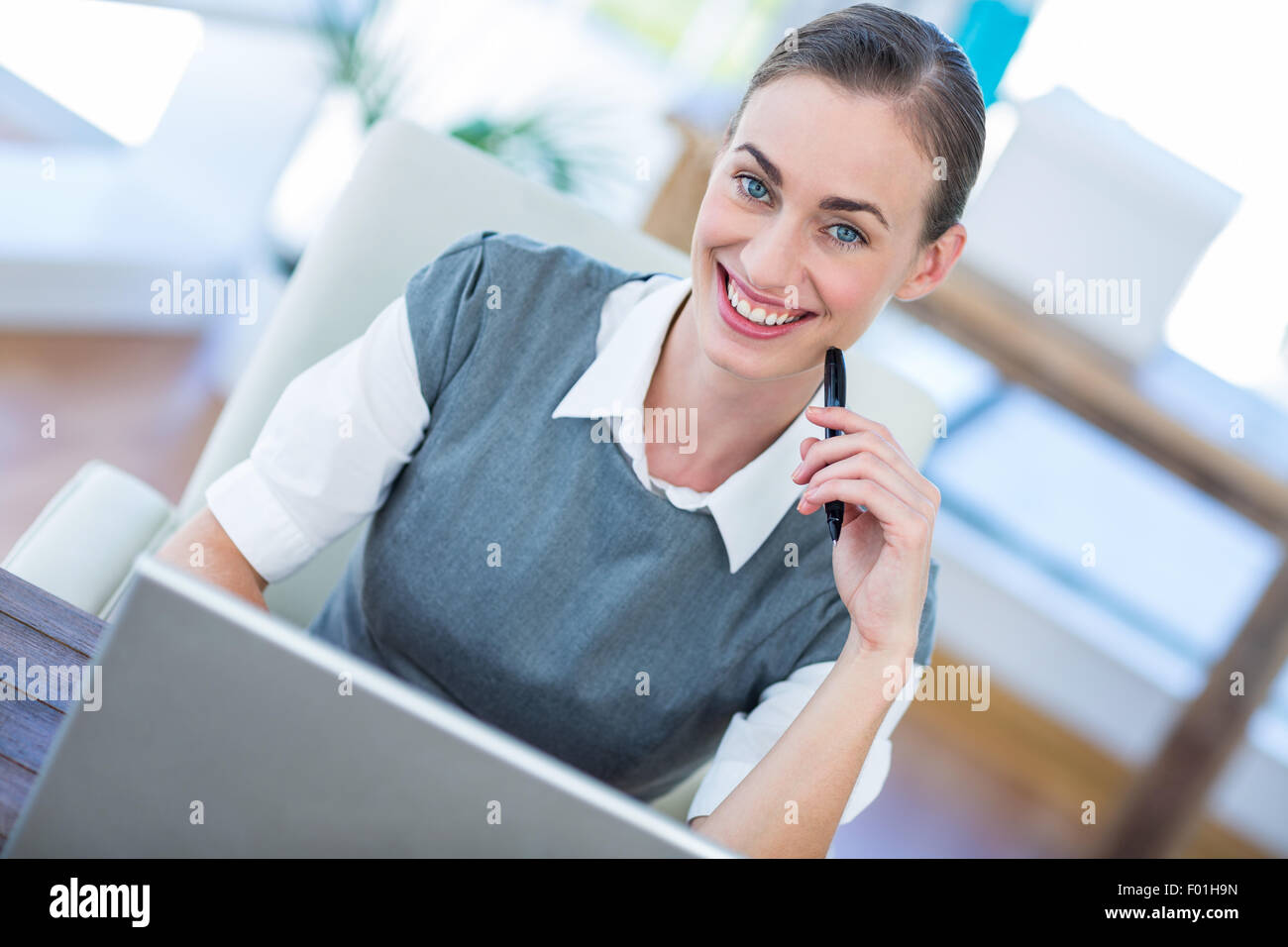 Happy businesswoman working on laptop computer Stock Photo - Alamy