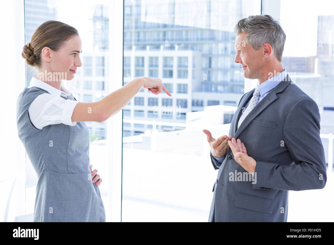 Business woman pointing her colleague Stock Photo - Alamy