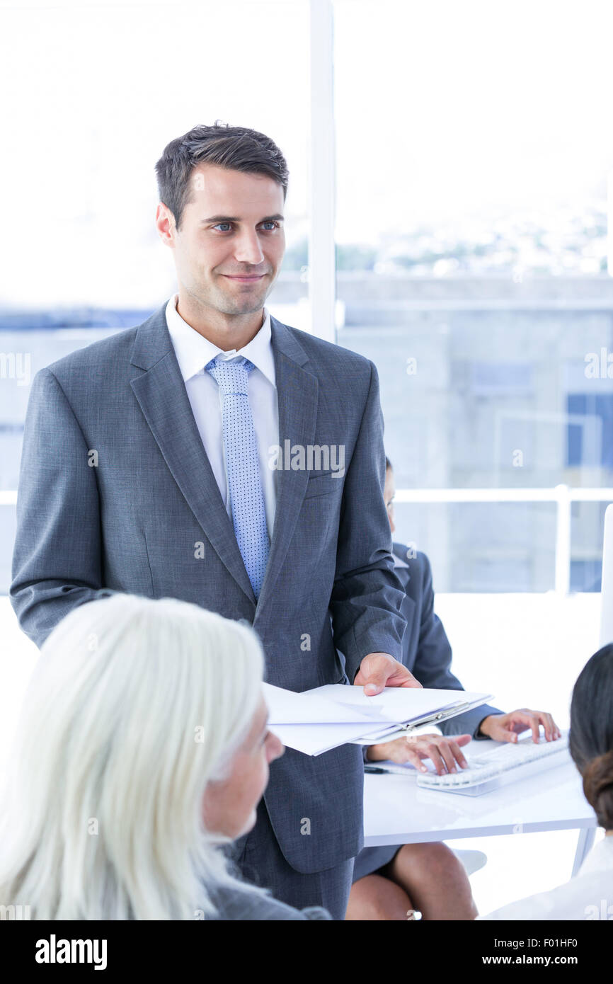 Businessman give a paper Stock Photo - Alamy