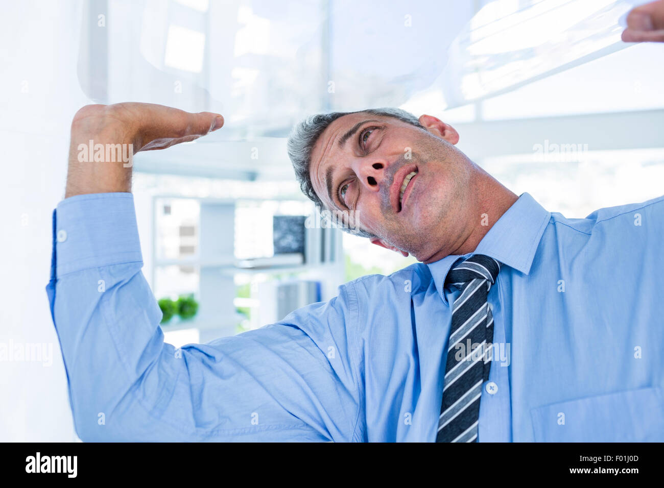 A serious businessman lifting something Stock Photo - Alamy