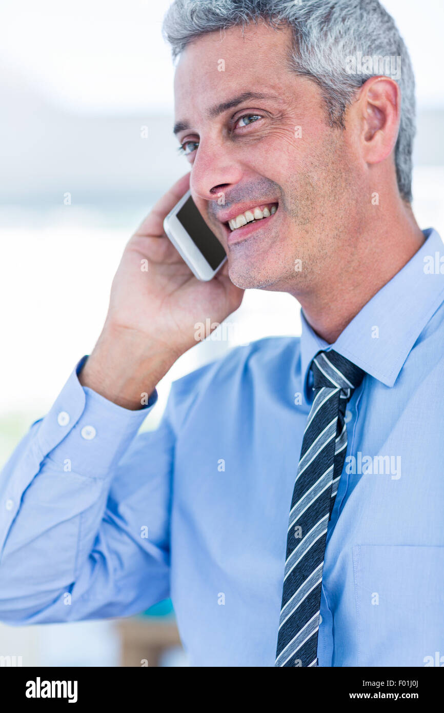 Happy businessman having a phone call Stock Photo - Alamy