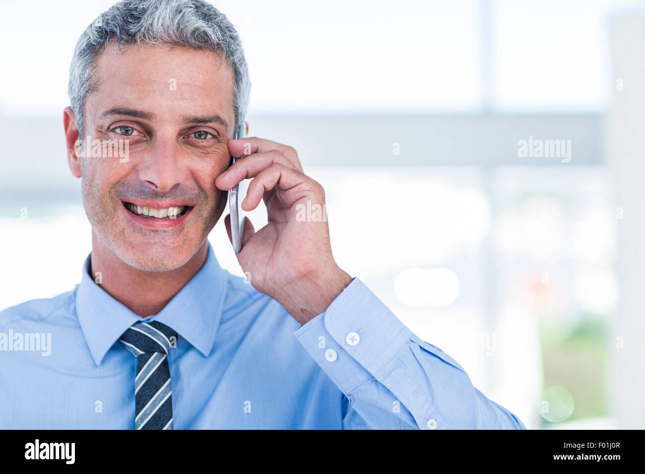 Happy businessman having a phone call Stock Photo - Alamy