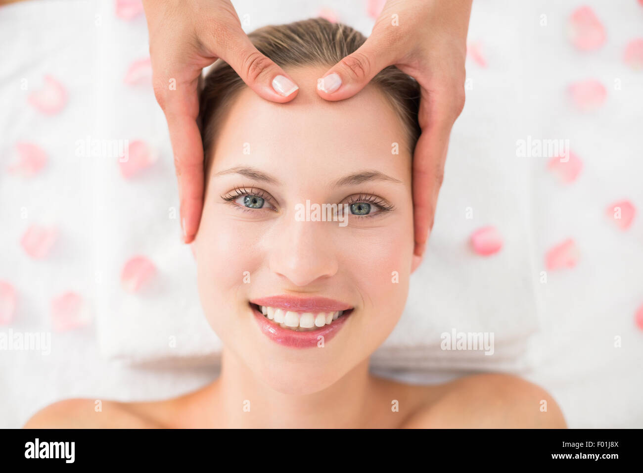 pretty blonde receiving head massage Stock Photo - Alamy