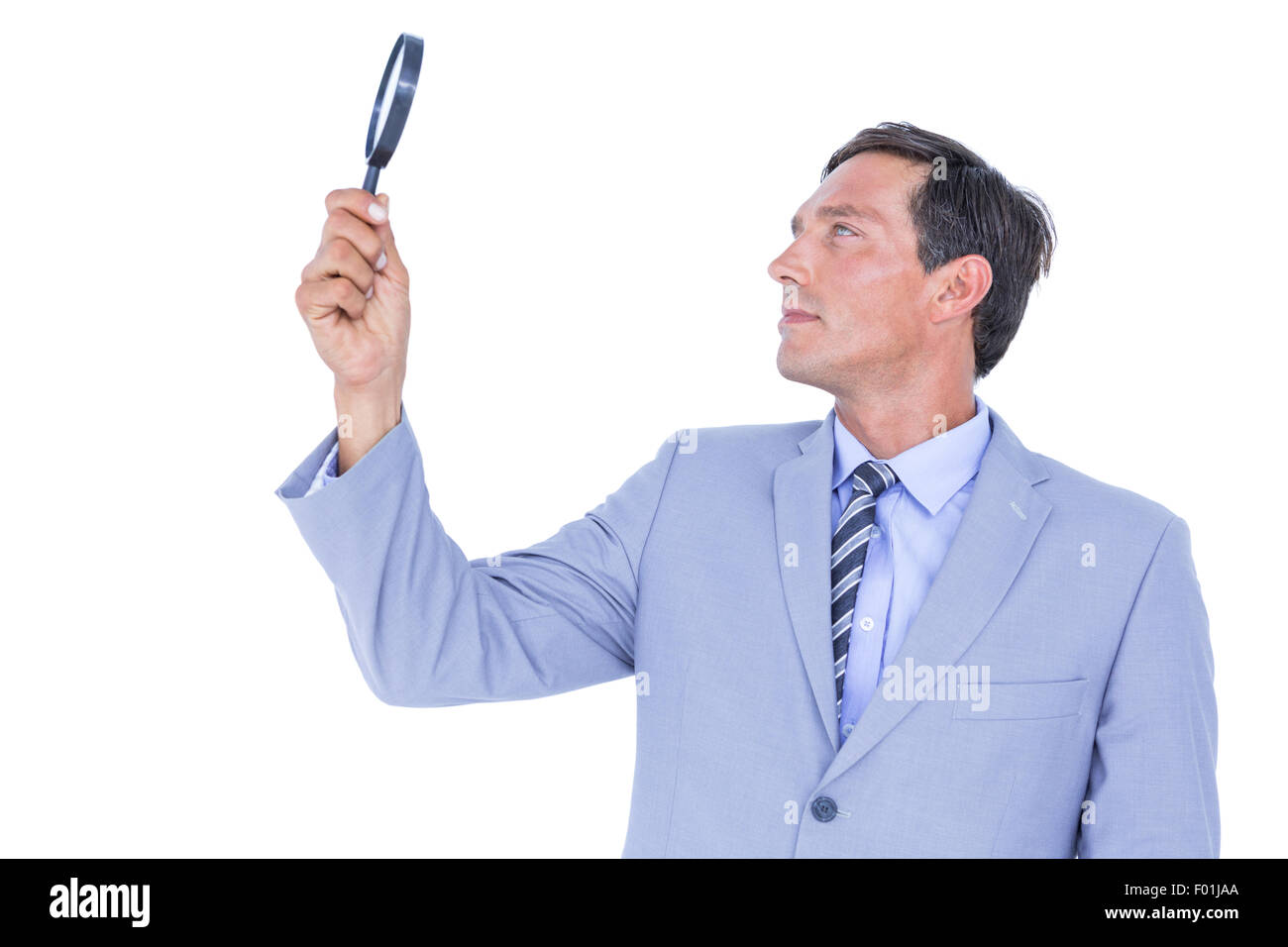 concentrated businessman using magnifying glass Stock Photo - Alamy
