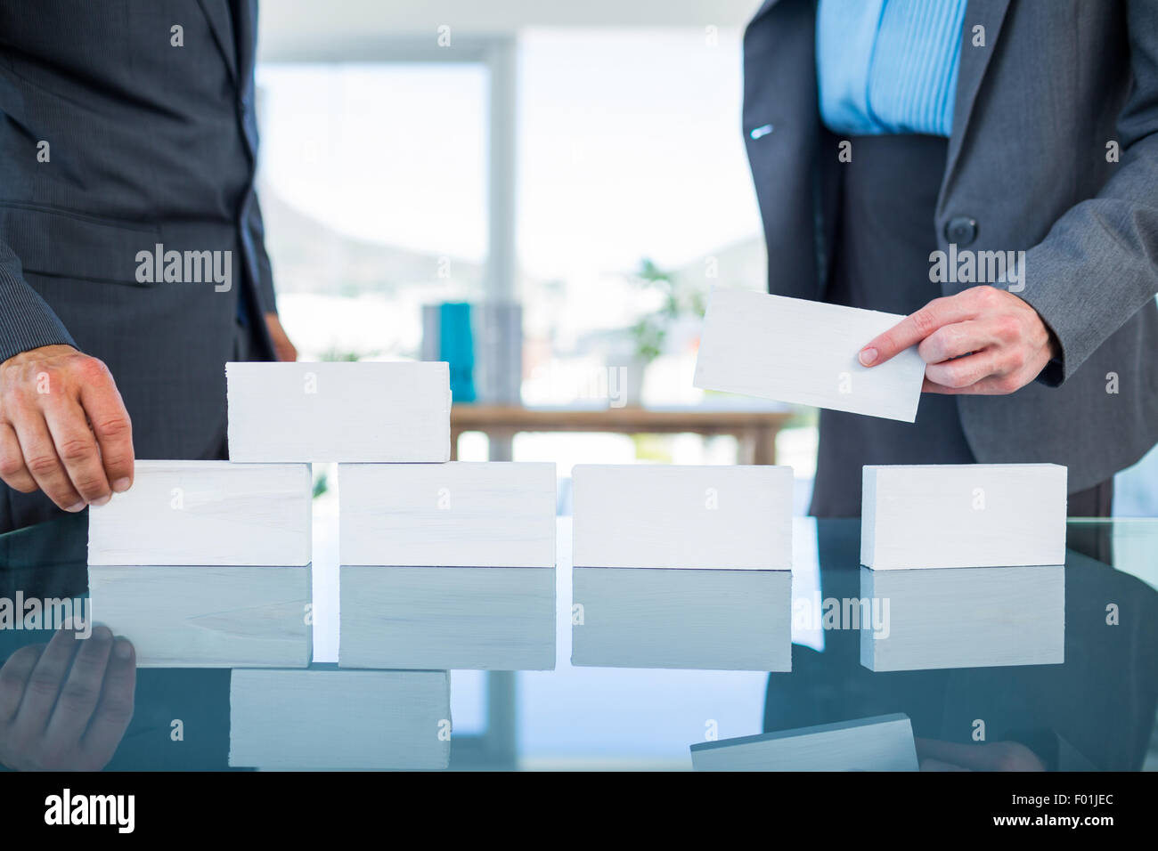 Business people stacking paper bloc Stock Photo - Alamy