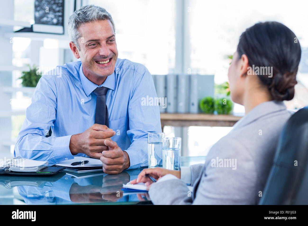 Happy business people speaking together Stock Photo - Alamy
