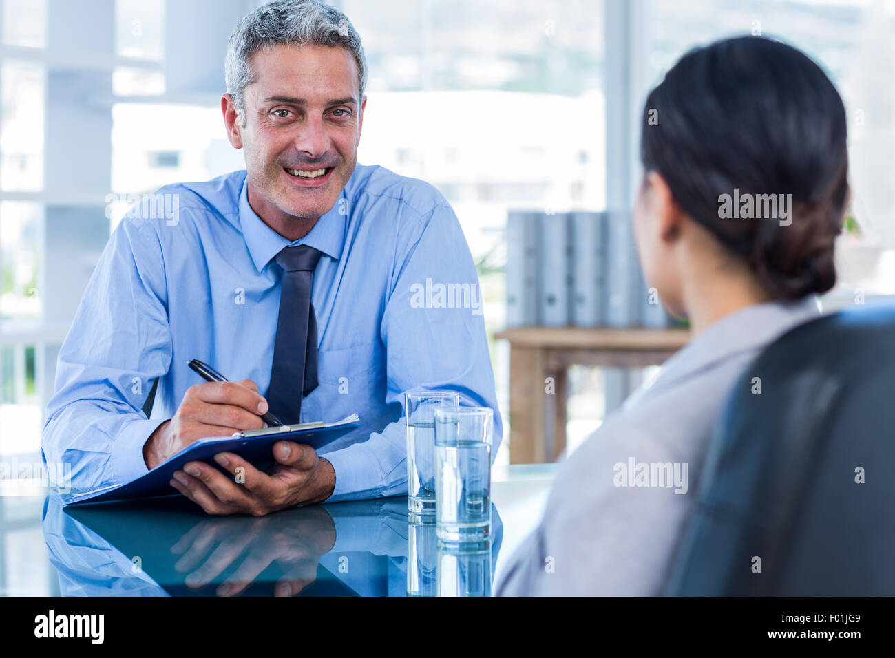 Happy business people speaking together Stock Photo - Alamy