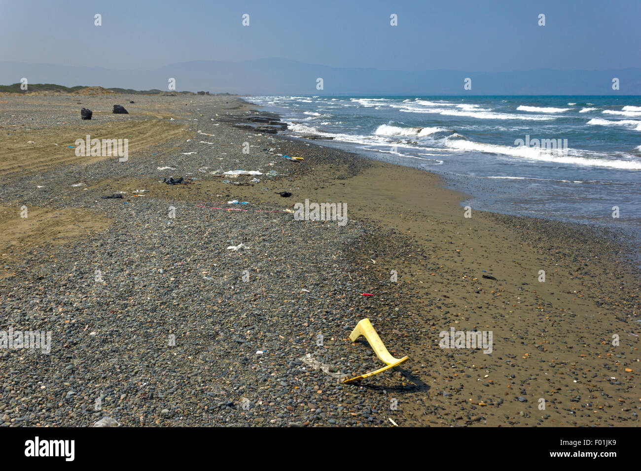 Pebbly Mediterranean beach showing the ocean and plastic pollutants ...