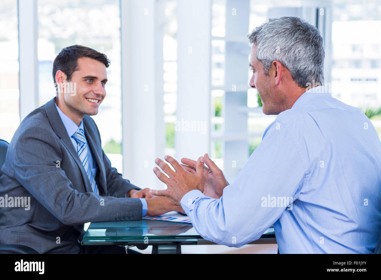 Happy business people speaking together Stock Photo - Alamy