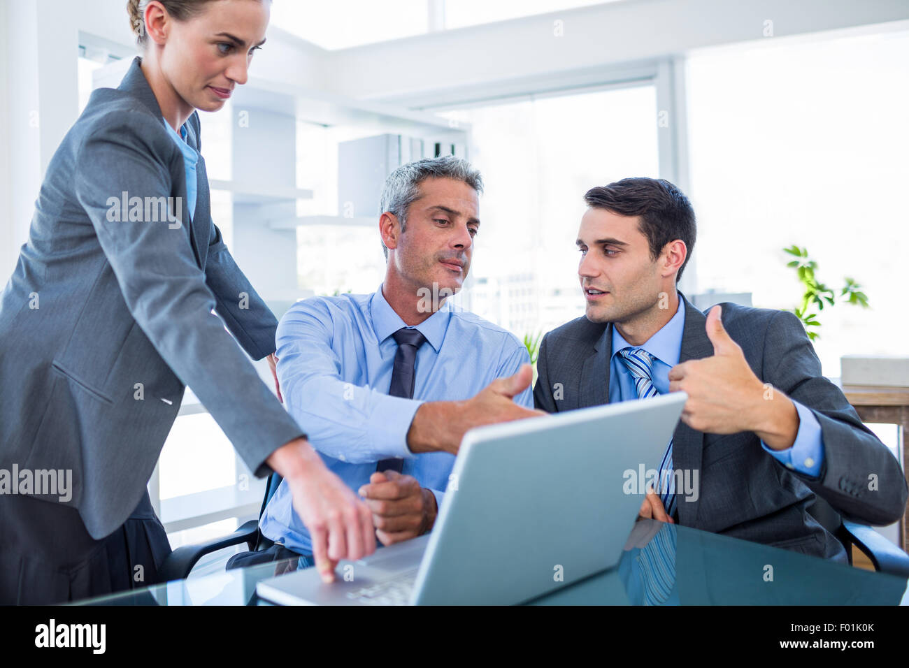Business people speaking together during meeting Stock Photo - Alamy