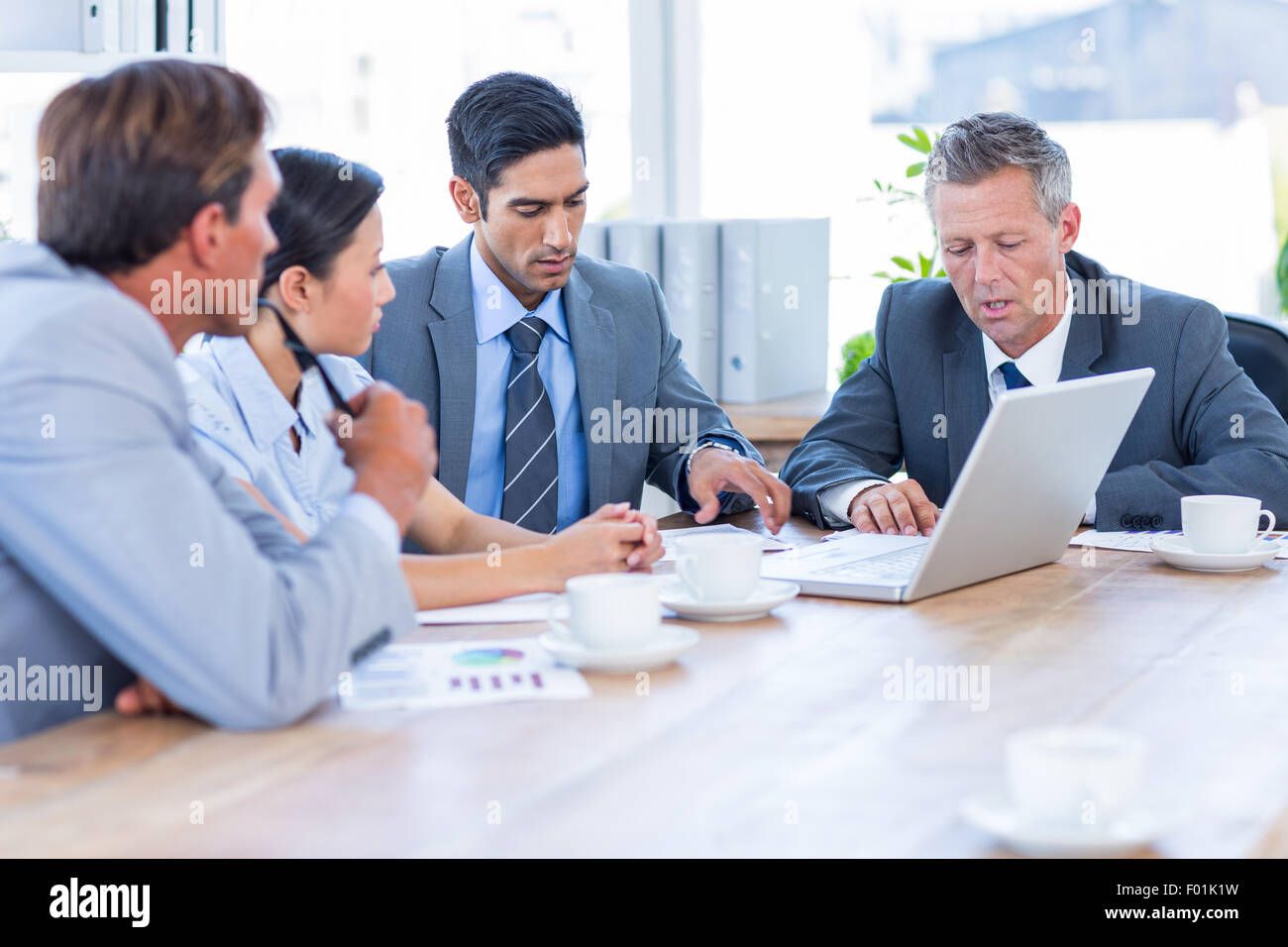 Business people speaking together during meeting Stock Photo - Alamy