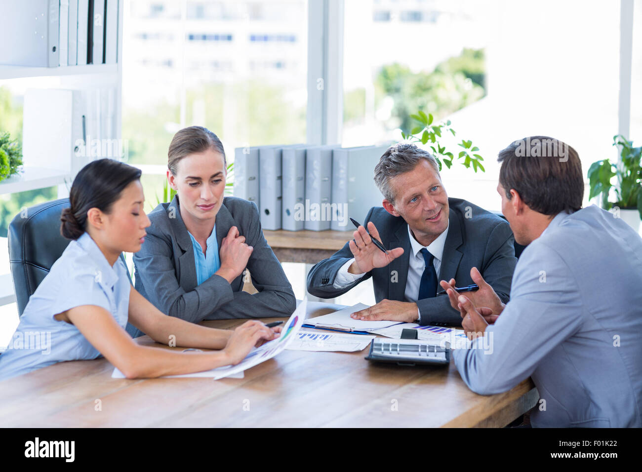 Business people speaking together during meeting Stock Photo - Alamy
