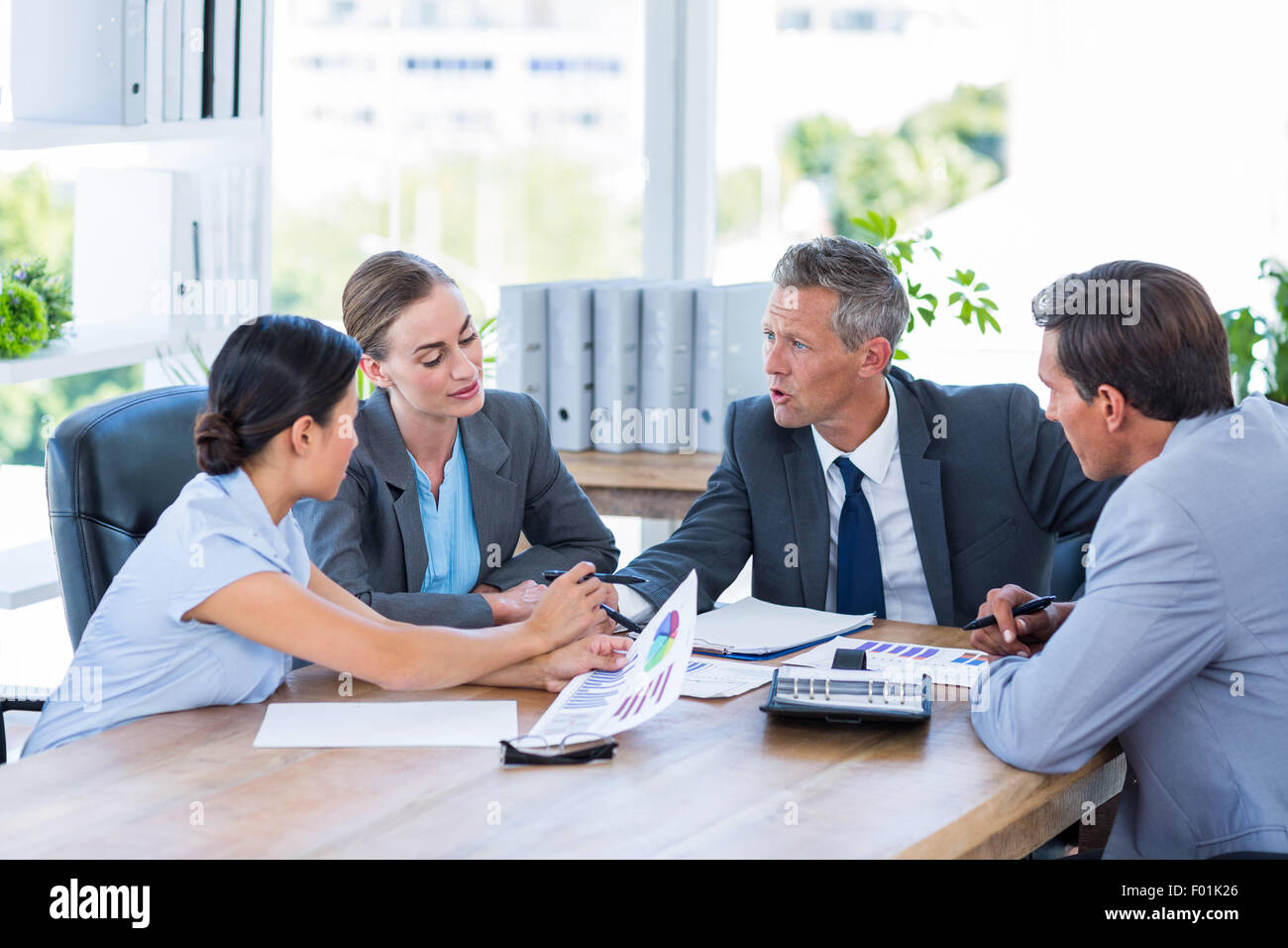 Business people speaking together during meeting Stock Photo - Alamy