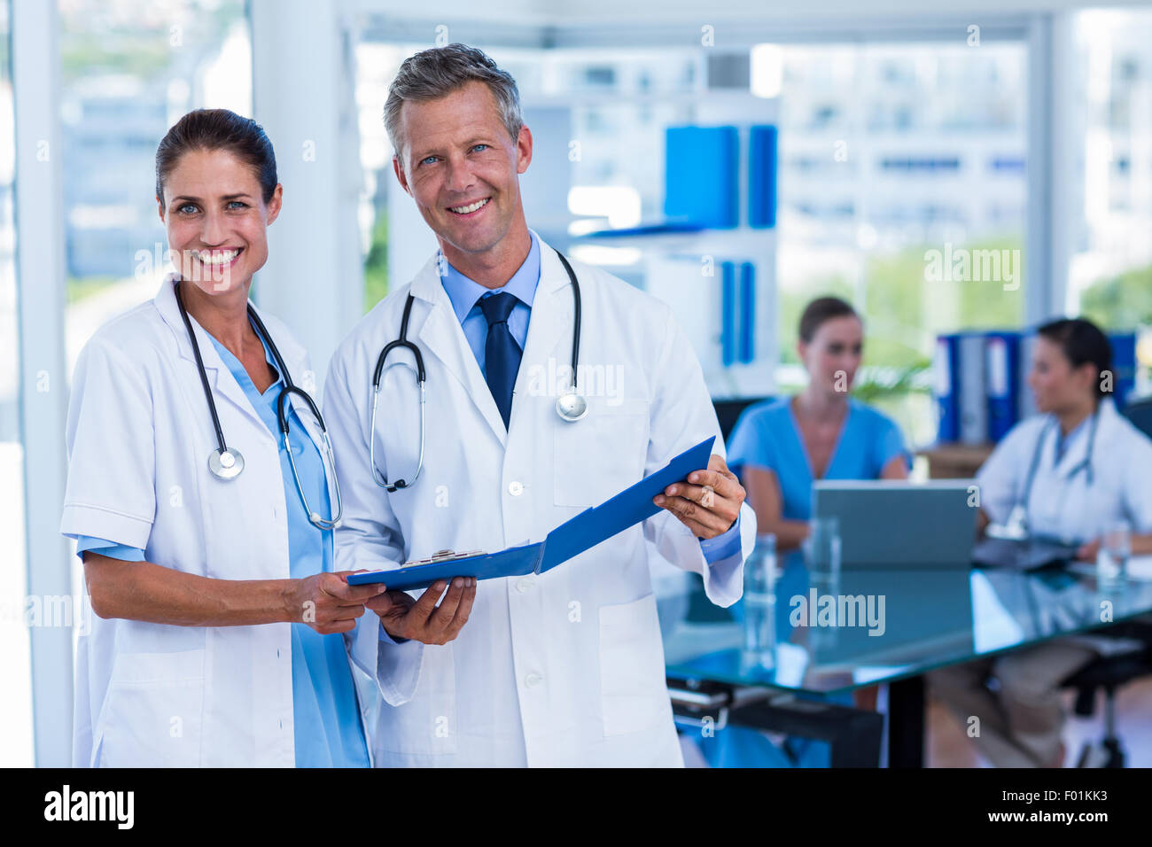 Happy doctors smiling at camera Stock Photo - Alamy