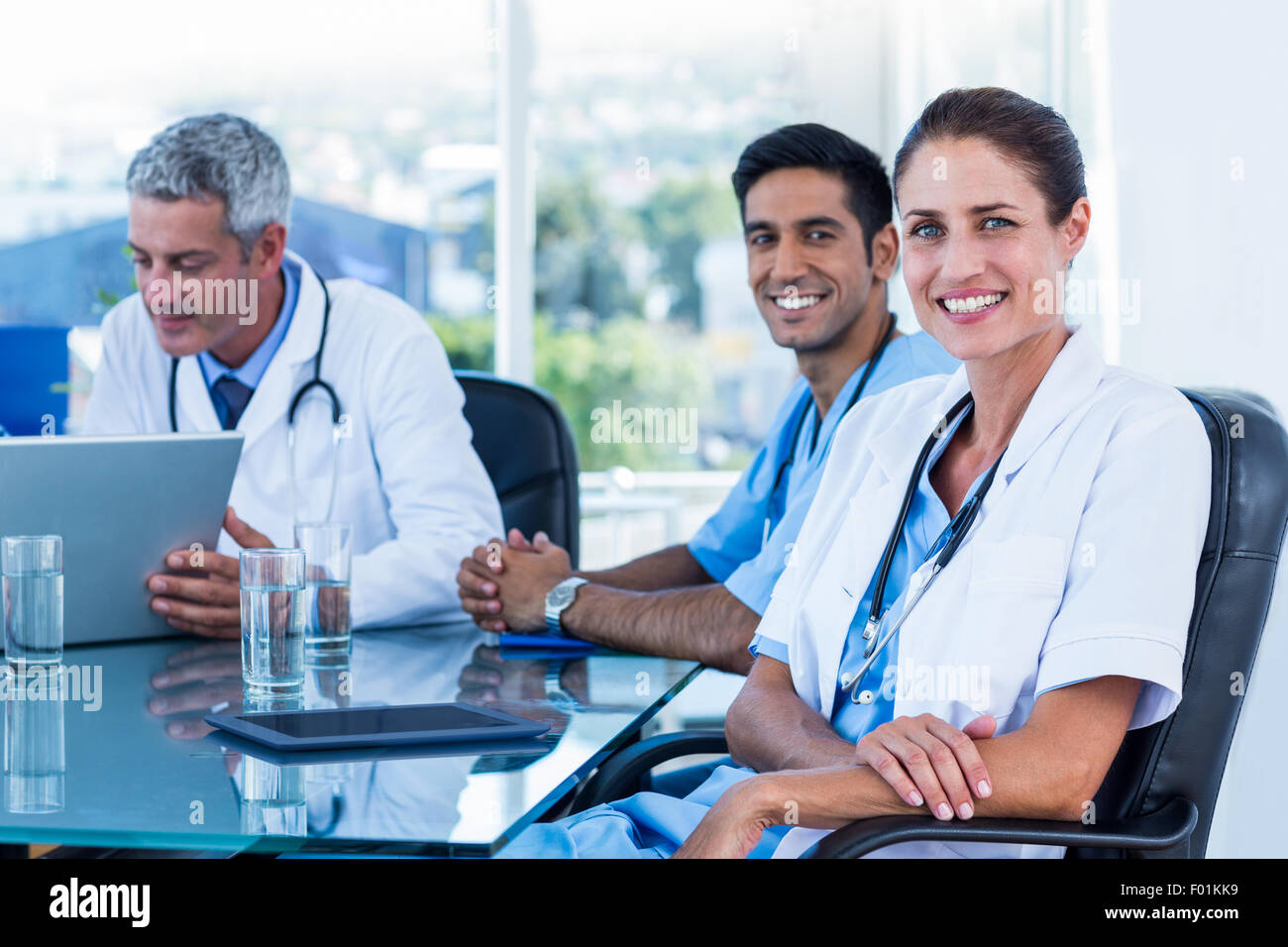Team of smiling doctors having a meeting Stock Photo - Alamy