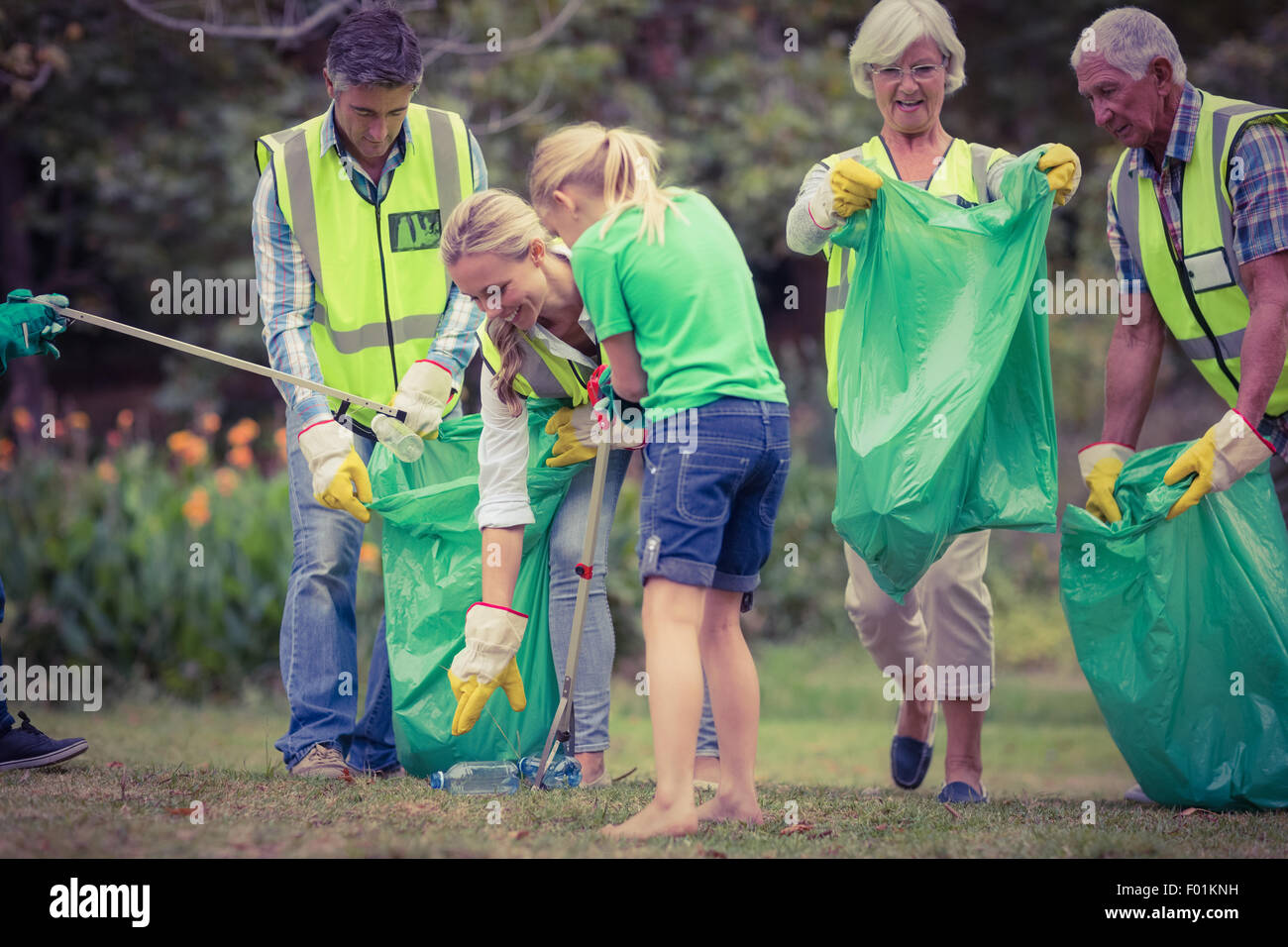 Happy family collecting rubbish Stock Photo - Alamy