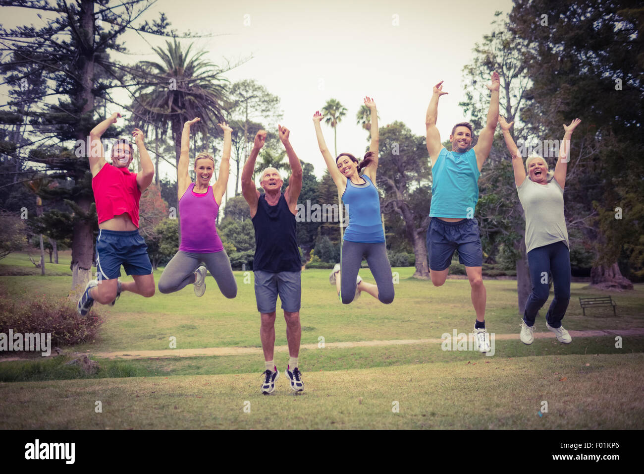 Happy athletic jumping together Stock Photo - Alamy