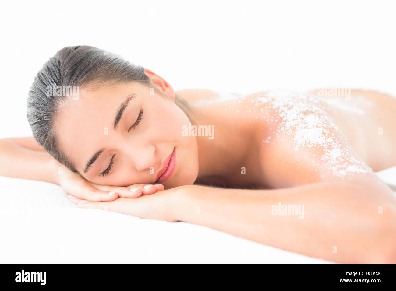 Beautiful brunette enjoying a salt scrub treatment Stock Photo - Alamy