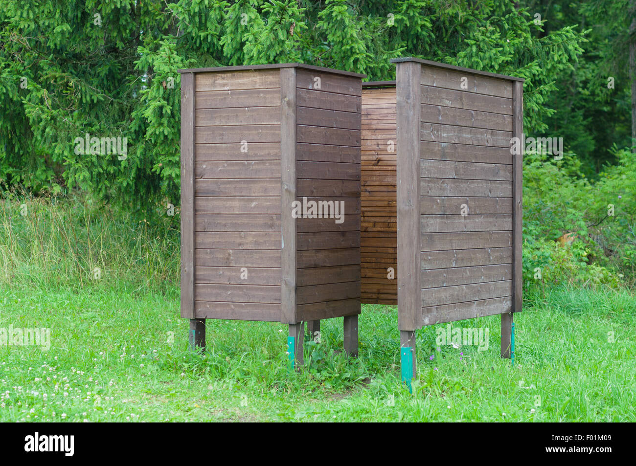 Wooden wear changing cabin near coniferous forest recreational area ...
