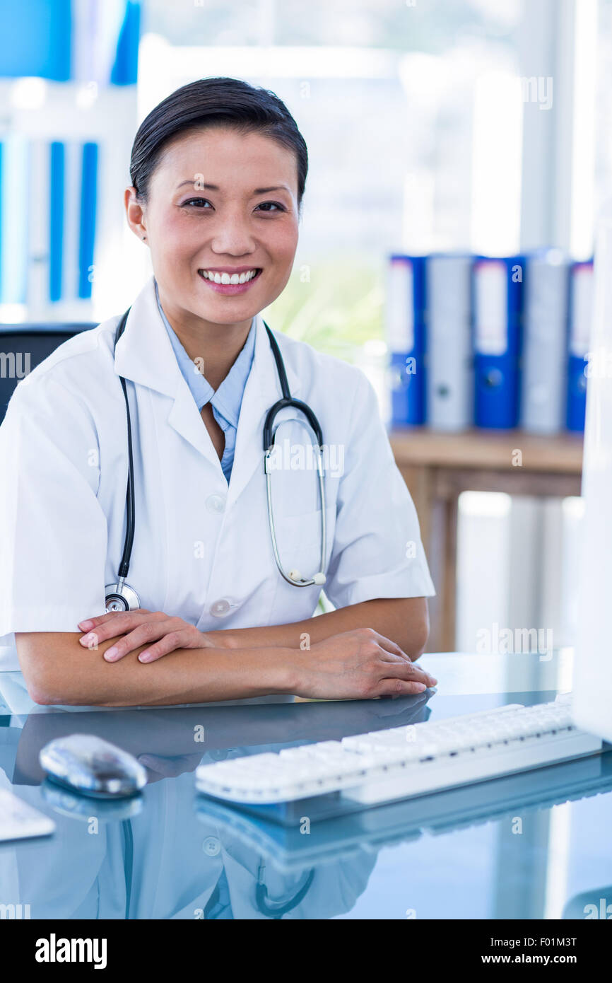 Smiling doctor looking camera arms hi-res stock photography and images ...
