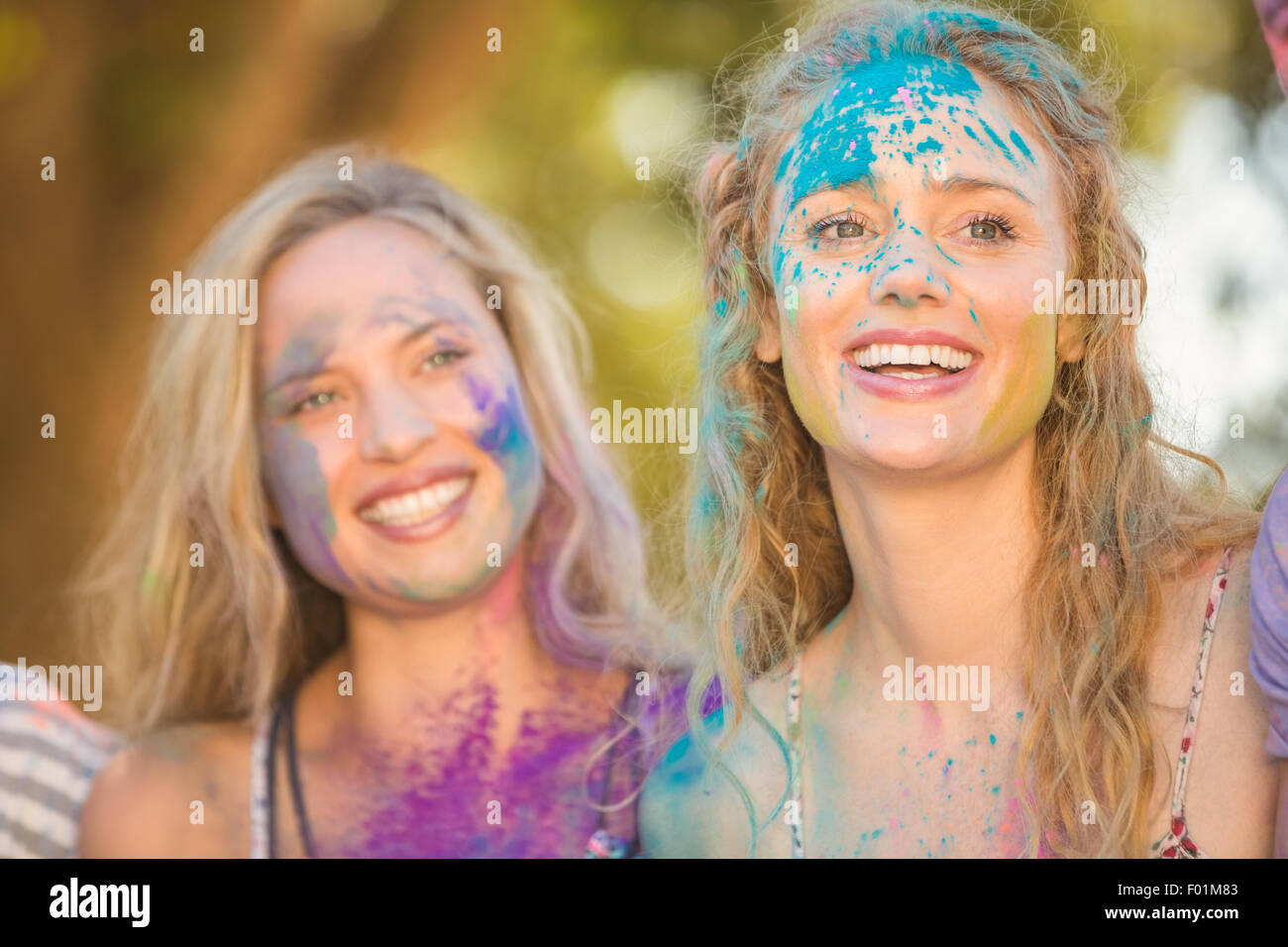 Friends having fun with powder paint Stock Photo - Alamy