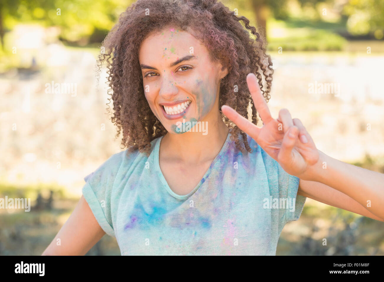 Young woman having fun with powder paint Stock Photo - Alamy