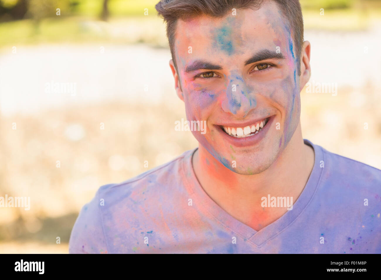 Young man having fun with powder paint Stock Photo - Alamy