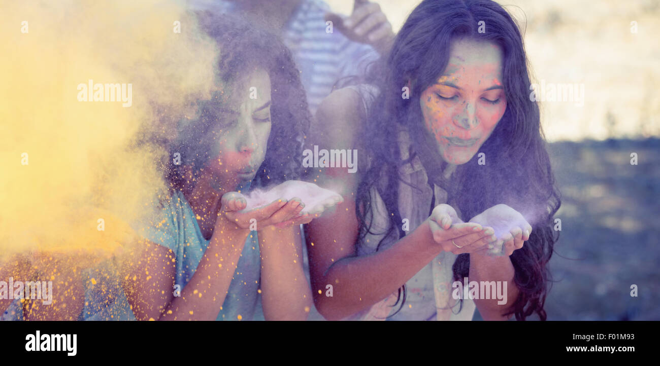 Young women having fun with powder paint Stock Photo - Alamy