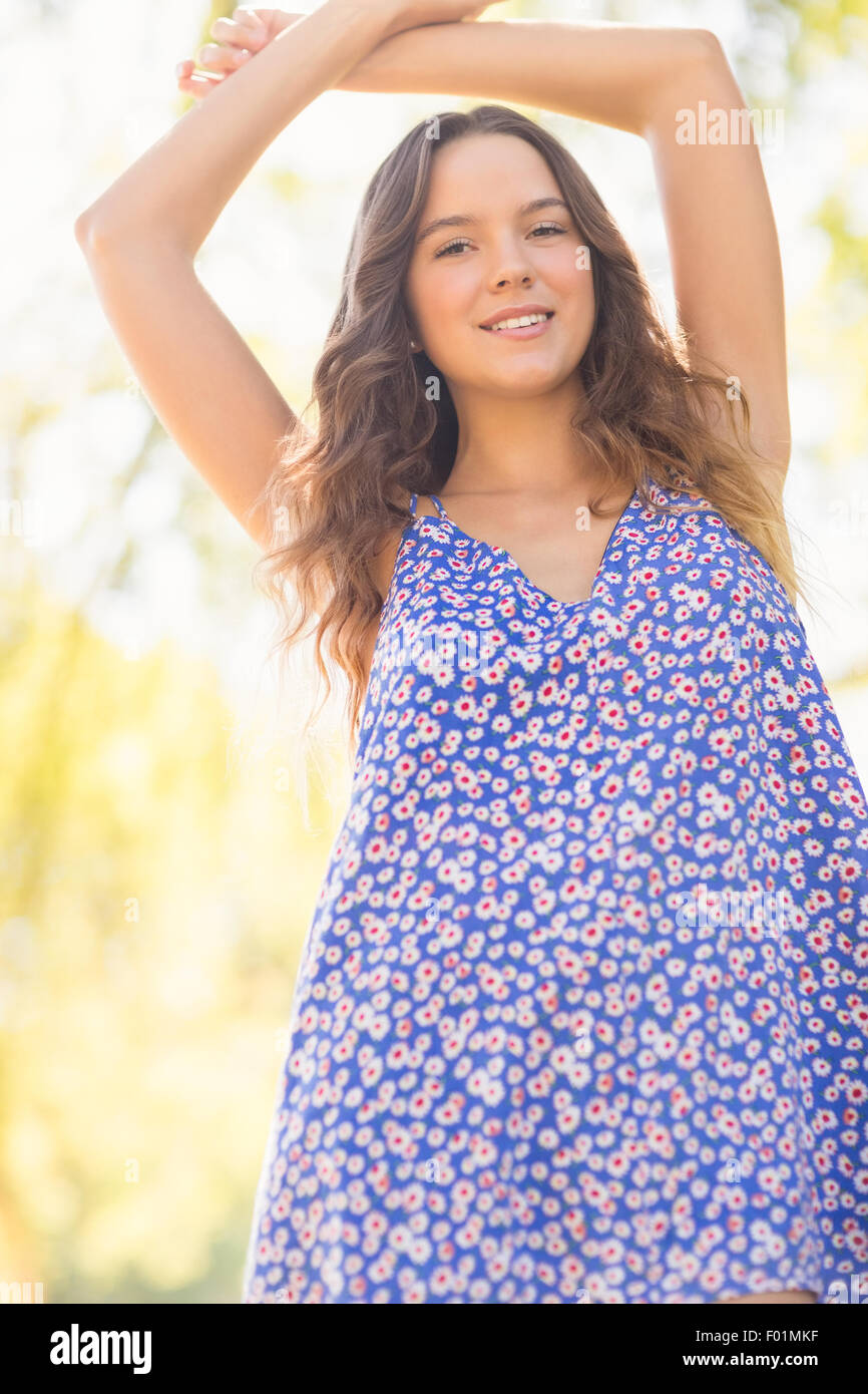 Pretty brunette standing arms raised Stock Photo - Alamy