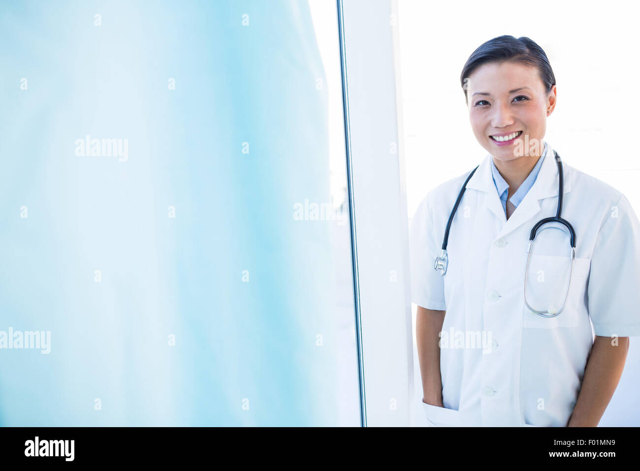 Confident female doctor smiling at camera Stock Photo - Alamy