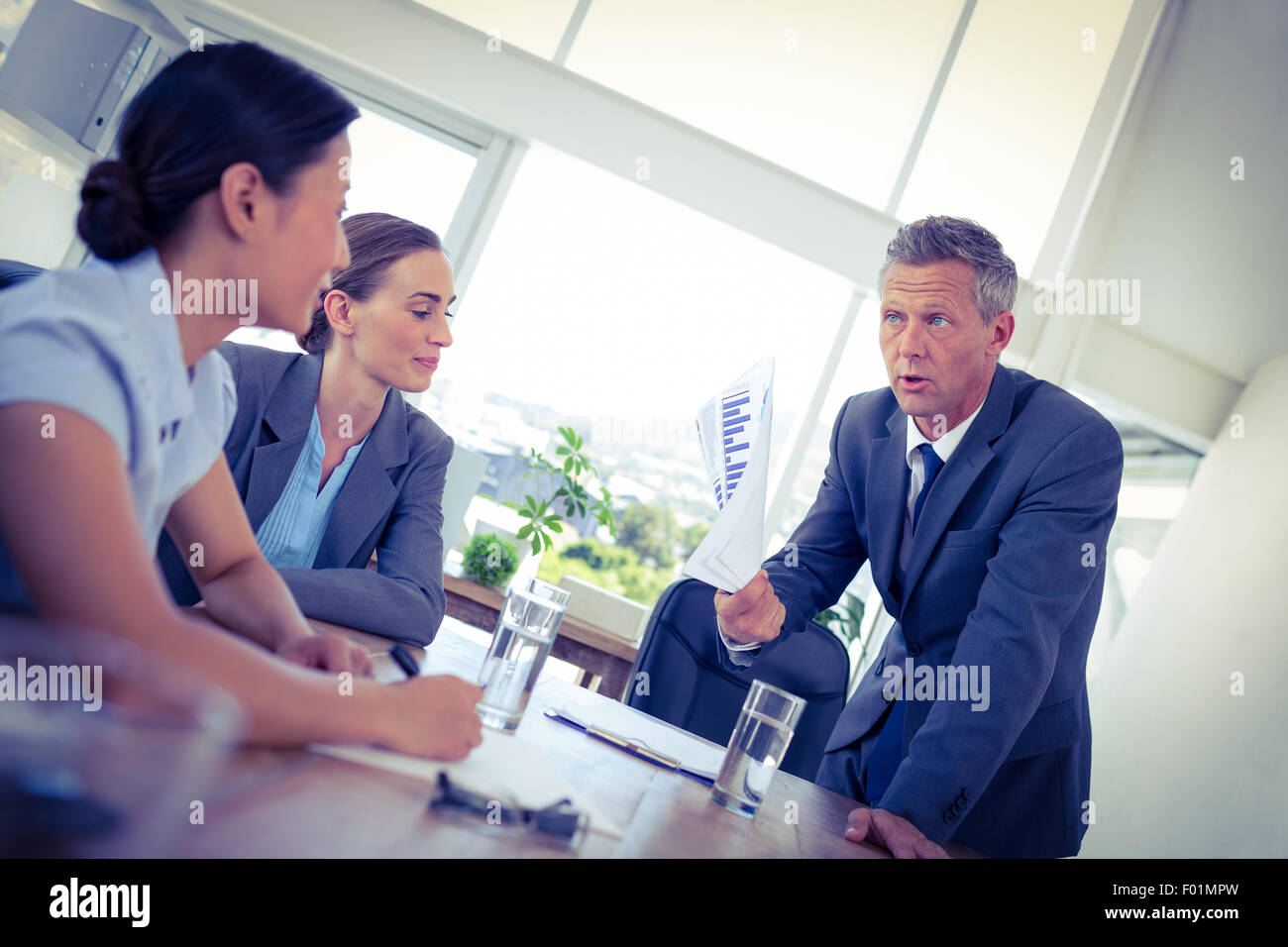 Businessman showing documents during meeting Stock Photo - Alamy