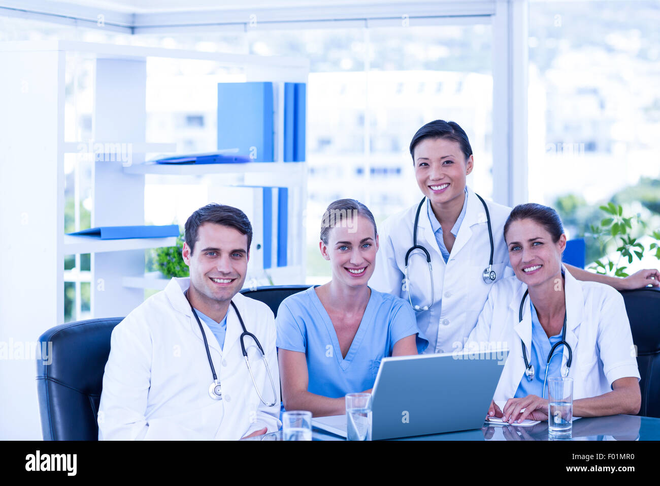 Medical team discussing smiling camera hi-res stock photography and ...