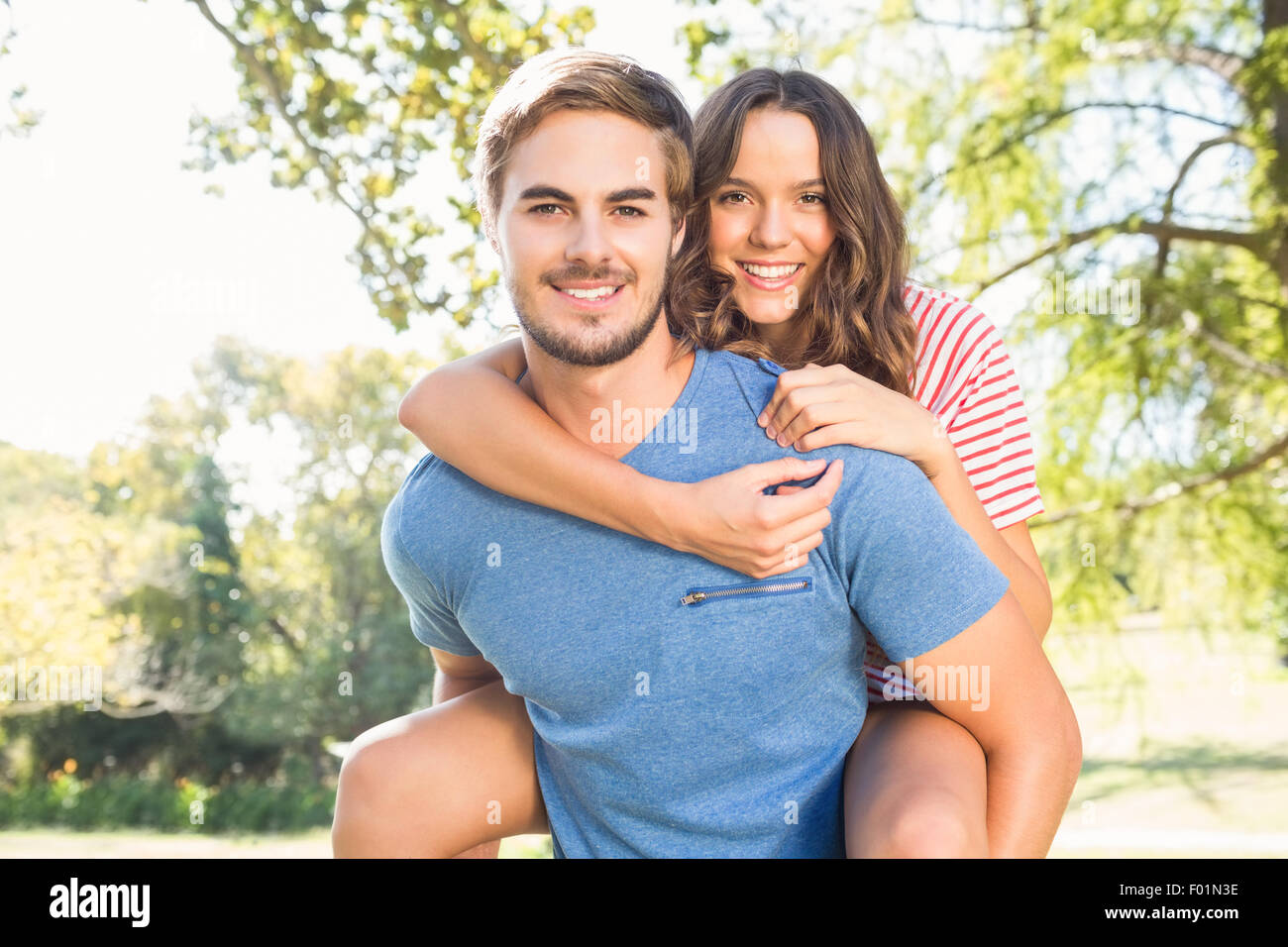 Cute couple having fun in park Stock Photo - Alamy