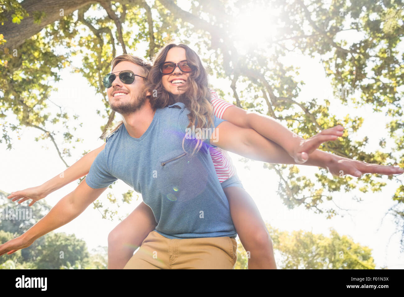 Cute couple having fun in park Stock Photo - Alamy