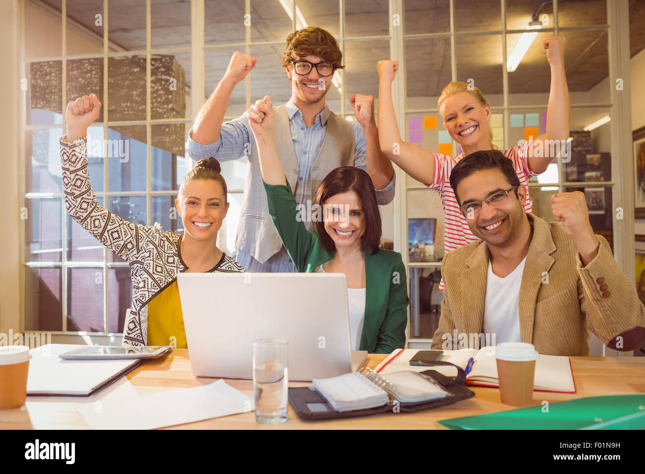 Group of young colleagues using laptop Stock Photo - Alamy