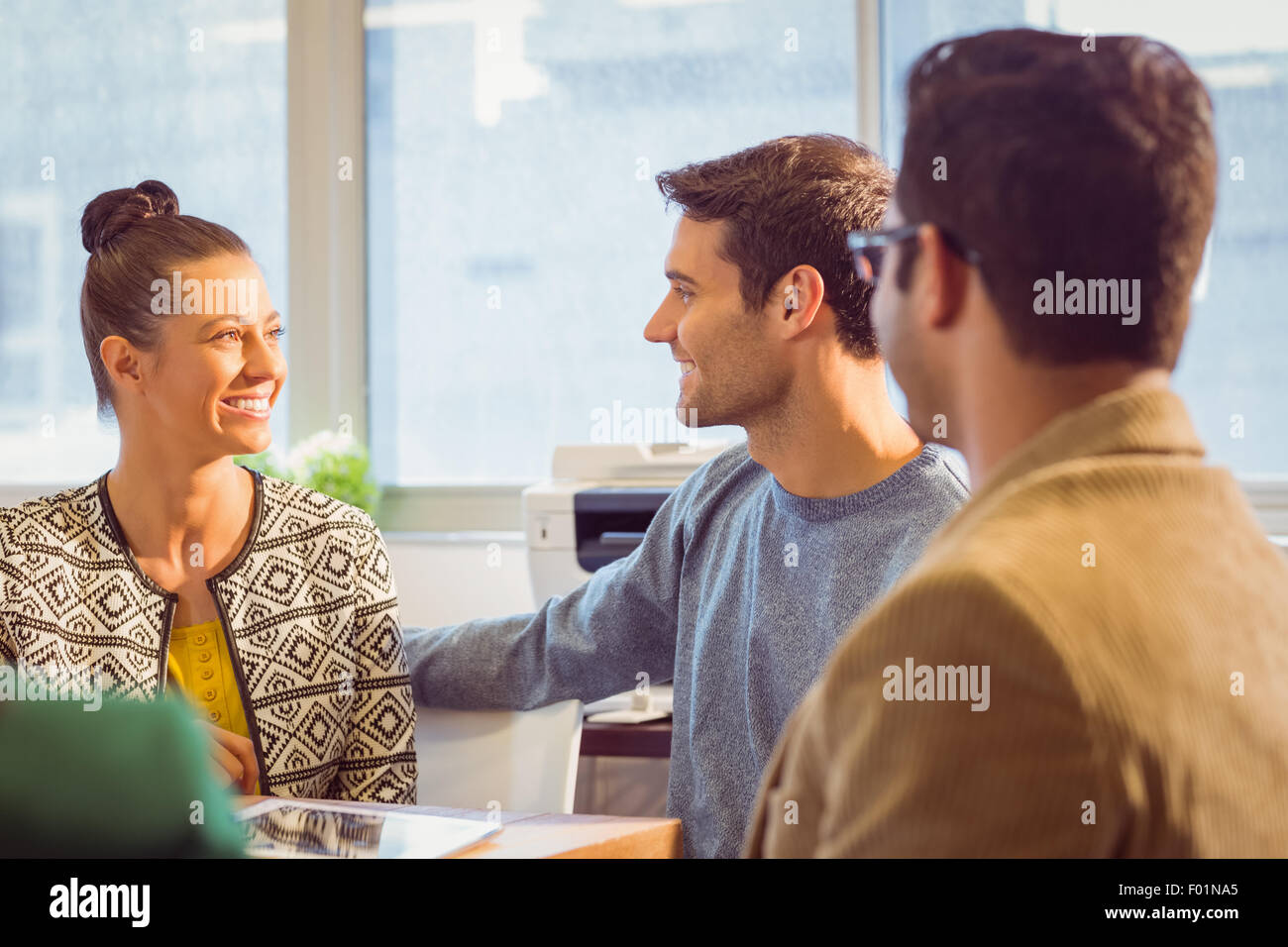 Smiling colleagues talking together Stock Photo - Alamy