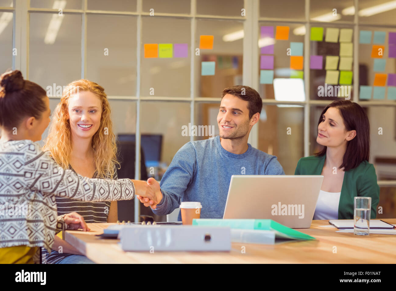 Group of young colleagues using laptop Stock Photo - Alamy
