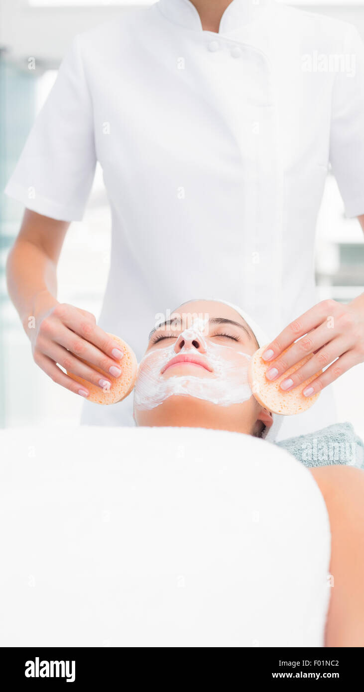 Hands cleaning woman face with sponge Stock Photo - Alamy